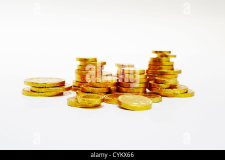 A stack of gold chocolate coins wrapped in a golden foil Stock Photo ...