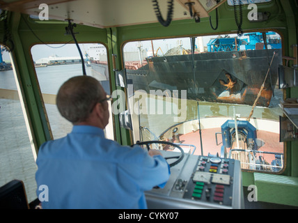 Boat captain steering his ship in the control room, the Lady Florence ...