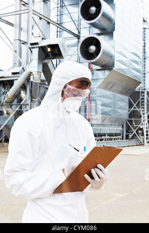Male scientist writing on a clipboard Stock Photo - Alamy