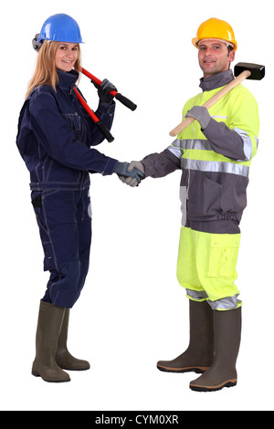 Tradespeople shaking hands Stock Photo - Alamy