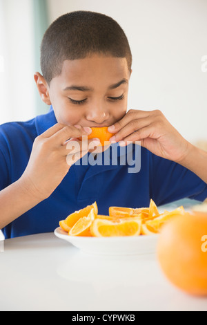 Boy holding oranges Stock Photo - Alamy