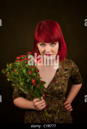 Pretty punky girl with brightly dyed red hair and flowers Stock Photo ...