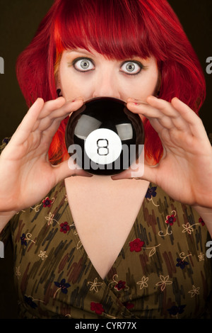 Pretty punky girl with brightly dyed red hair listening to music Stock ...