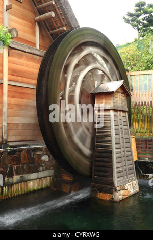 a wooden waterwheel is rotating Stock Photo - Alamy