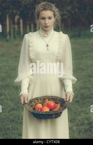 Woman with basket with fruits in hand at the window Stock Photo - Alamy