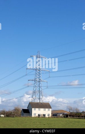 ELECTRICITY PYLON AND CABLES NEAR TO HOUSE Stock Photo - Alamy
