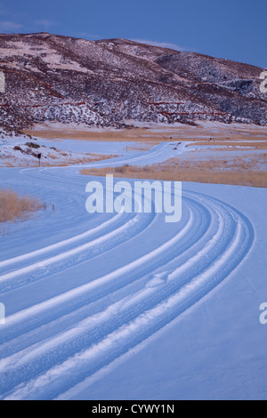 windy ranch road in Colorado mountain valley, fall evening after sunset ...