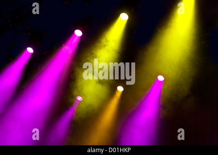 Shafts of coloured colored lighting shine through atmospheric smoke in ...