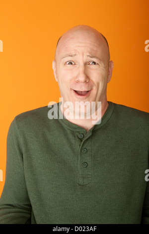 Bemused middle-aged Caucasian man on orange background Stock Photo - Alamy