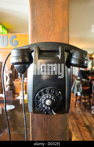 Antique wall mounted telephone on wall in hallway inside old 1800s ...
