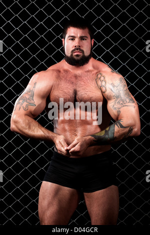 Strong bodybuilder with muscular chest and shoulders in gym Stock Photo ...