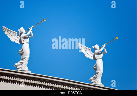 Statue of an angel playing a trumpet with two horns Stock Photo - Alamy