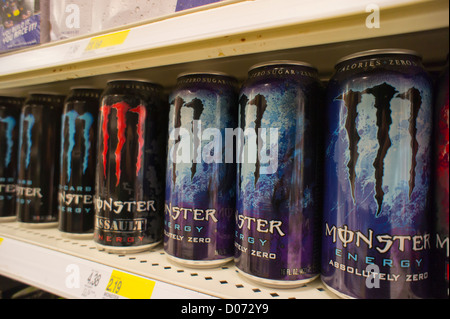 Cans of Monster Energy drink on sale on a shelf in a supermarket in the ...