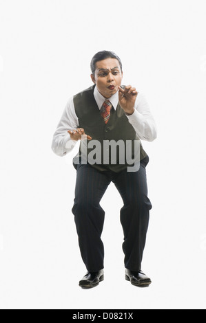 Man with a face mime working on a laptop isolated on a white background ...