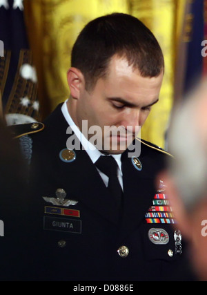 U.S. Army Staff Sergeant Salvatore Giunta bows his head during the ...