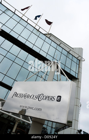 PwC logo sign on an office building. PricewaterhouseCoopers is the name ...