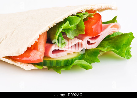 Pitta bread pocket filled with salad tomato cucumber and ham Stock ...
