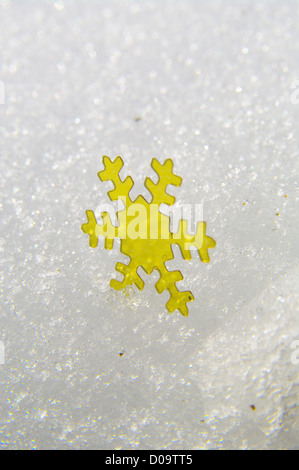 golden snow stars on a real snowy icy surface Stock Photo - Alamy