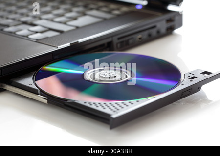 Inserting a CD into a CD rom drive on a laptop computer Stock Photo - Alamy