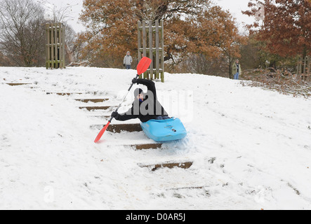 A man practicing his kayaking skills down some snow covered stairs in ...