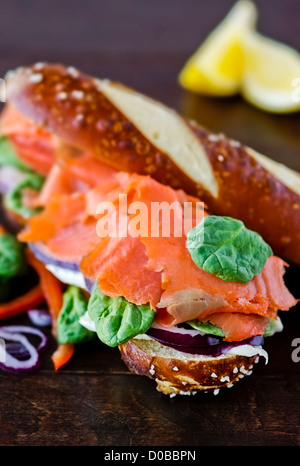 Red fish sandwich with wholegrain bread, cucumber, herbs and tomatoes ...