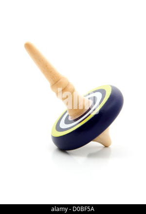 One blue spinning top on orange background Stock Photo - Alamy