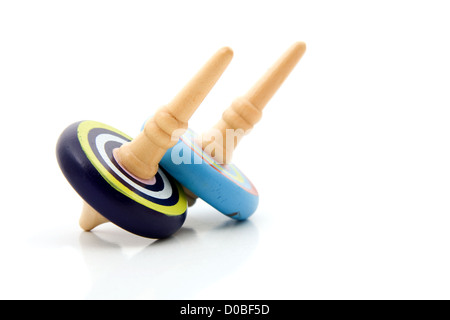 Two colorful spinning tops on white background Stock Photo - Alamy