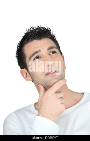 Skeptical and doubtful Black man staring at camera unsure, pointing ...