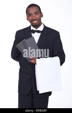 Waiter showing menus Stock Photo - Alamy