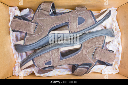 Cardboard box with male shoes on white background Stock Photo - Alamy
