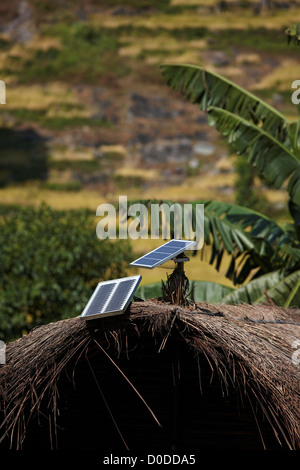 Small Solar Panels on Thatch Roof Huts Stock Photo - Alamy