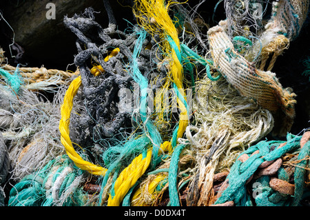 Plastic waste from fishing nets and ship's ropes tangled on the beach ...