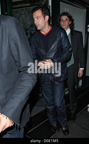 Clive Owen tries to hide behind his friends as he left the Ivy Club ...