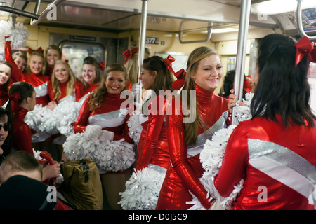 Members of the Varsity Spirit cheerleading team, travel via the subway ...