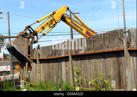Fence being demolished by an excavator Stock Photo: 52078574 - Alamy