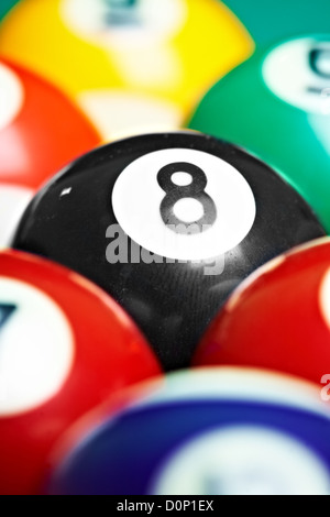Close-up photo of a set of multi-colored push pins fixed in a table ...