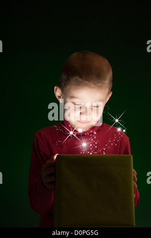 boy with present, light coming out of the box Stock Photo - Alamy