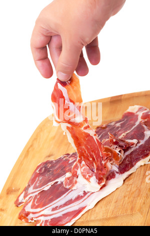 Thinly Sliced Spanish Jamon with a Hand, on a white background Stock ...