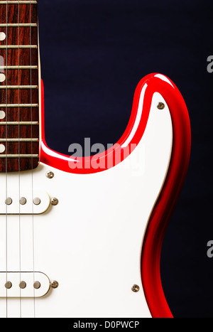 Part of a red and white electric guitar isolated on pink background ...