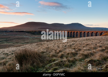 Ingleborough and ribblehead viaduct with early morning mist at sunrise ...
