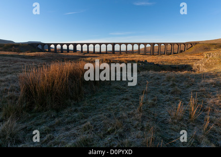 Ingleborough and ribblehead viaduct with early morning mist at sunrise ...