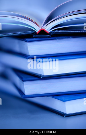 render of an open book,a stack of books and an at sign Stock Photo - Alamy