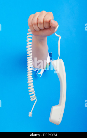 Hand with phone out of paper hole Stock Photo - Alamy