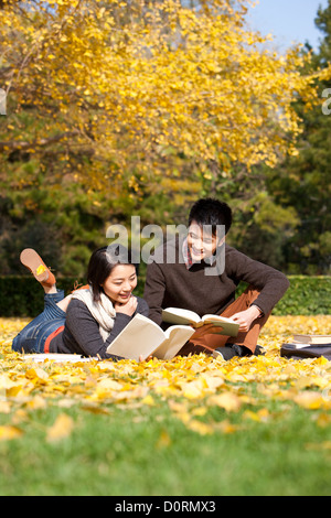 Merry college couple with books in the golden autumn on campus Stock ...