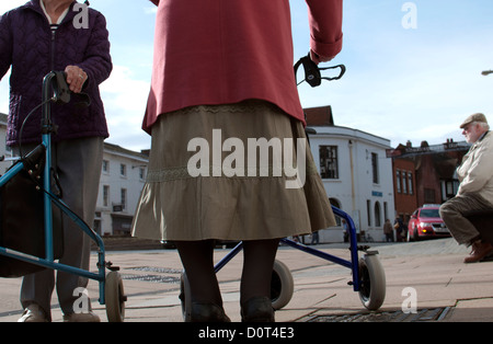 Elderly woman using a 3 wheeled walking frame Stock Photo - Alamy