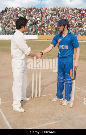 Two cricket players shaking hands Stock Photo - Alamy