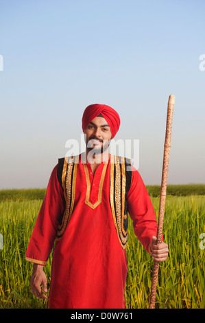 Bhangra dancer holding a stick Stock Photo - Alamy
