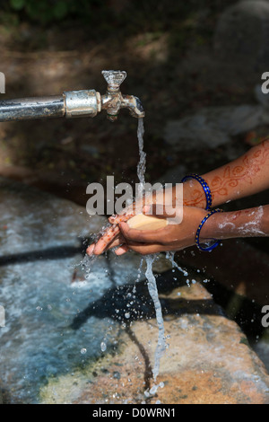 4 people hand washing at a communal wash stand Stock Photo - Alamy