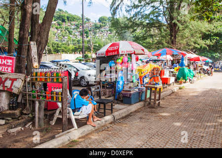 Beach-side stall at Surin Beach, Phuket, Thailand with Wat Surin in the ...