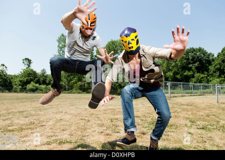 Two young men wearing wrestling masks Stock Photo - Alamy